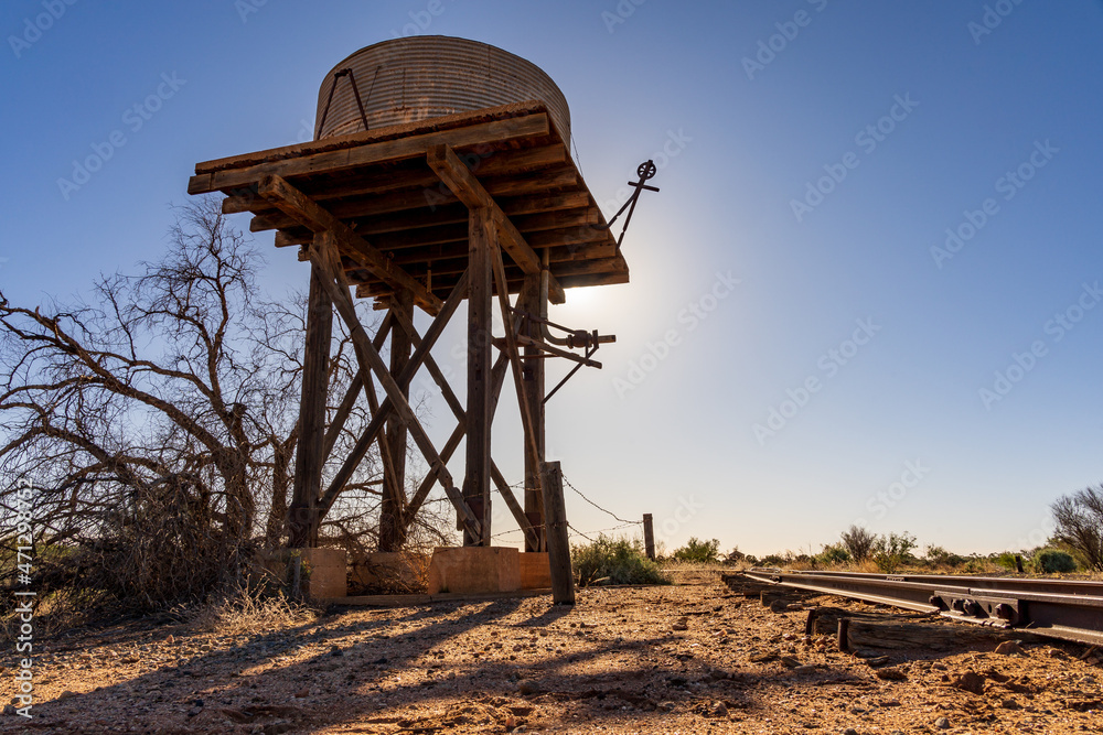 Looking up at a rustic wooden tank stand with an old water tank on top ...