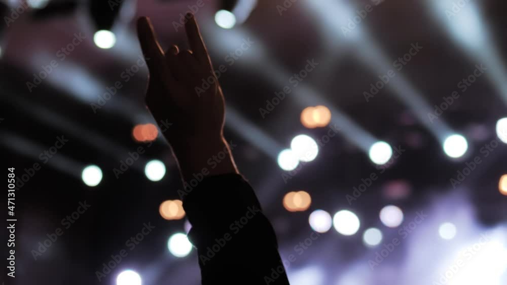 Close up: man partying, raising hands up, showing sign - devil horns ...