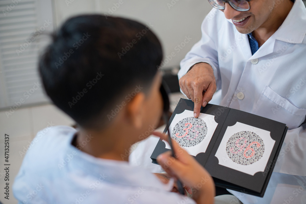 Indian optometrist or optician get color blindness tested for child boy ...