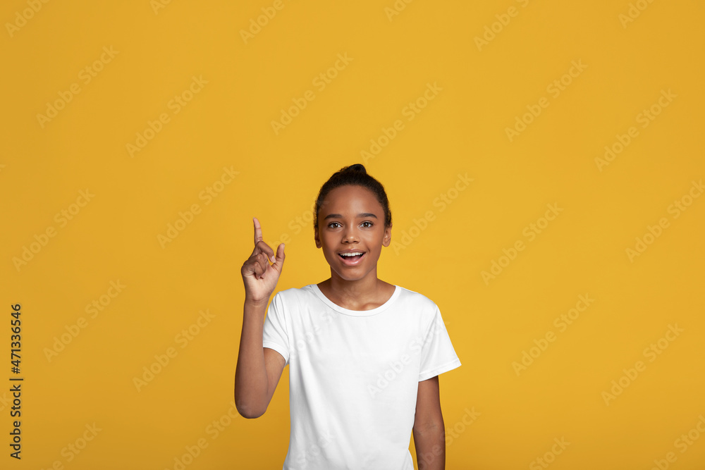 Shocked cute teenage afro american girl in white t-shirt shows thumbs ...
