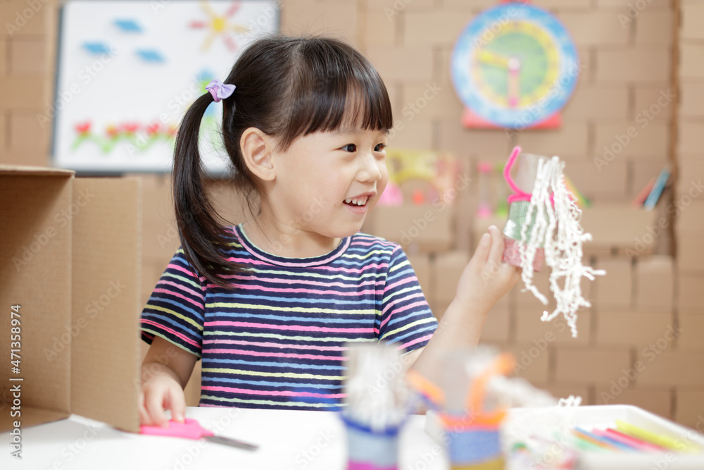 young girl making craft for homeschooling Stock Photo | Adobe Stock