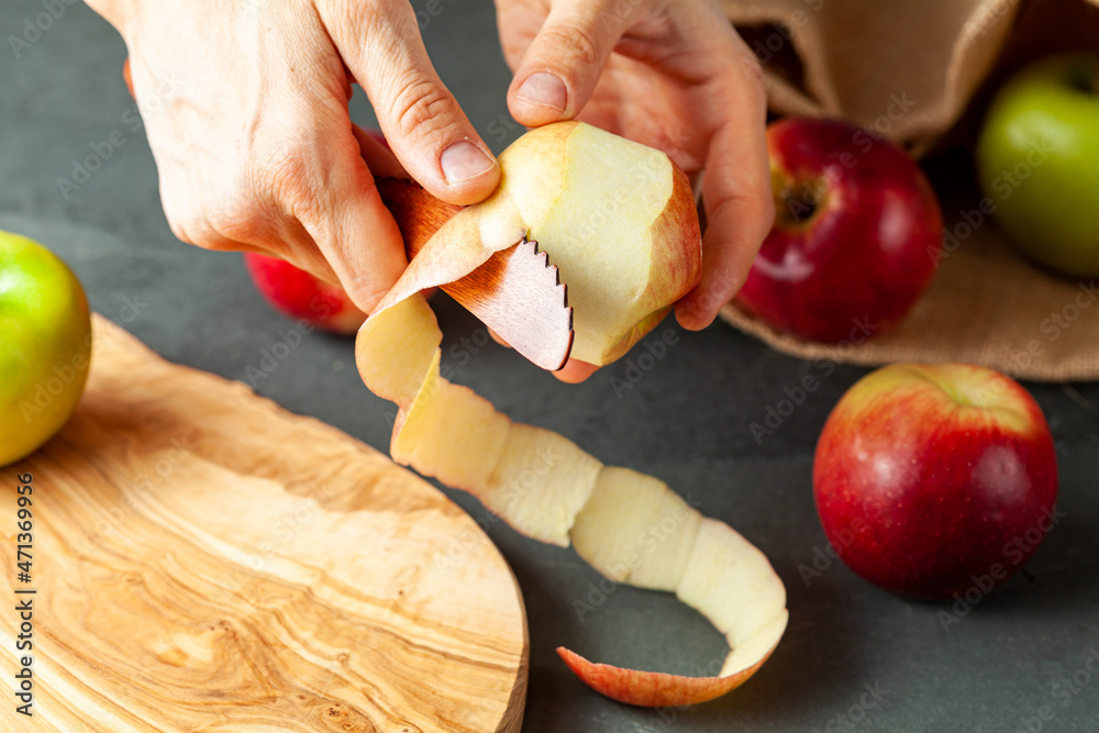 apples of different varieties are seen on dark stone and wooden ...