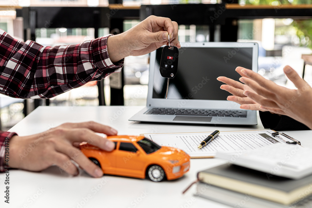 Person holding the car key to the car rental company employee, the ...