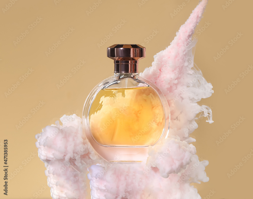 Perfume bottle in light smoke on beige background Stock Photo | Adobe Stock
