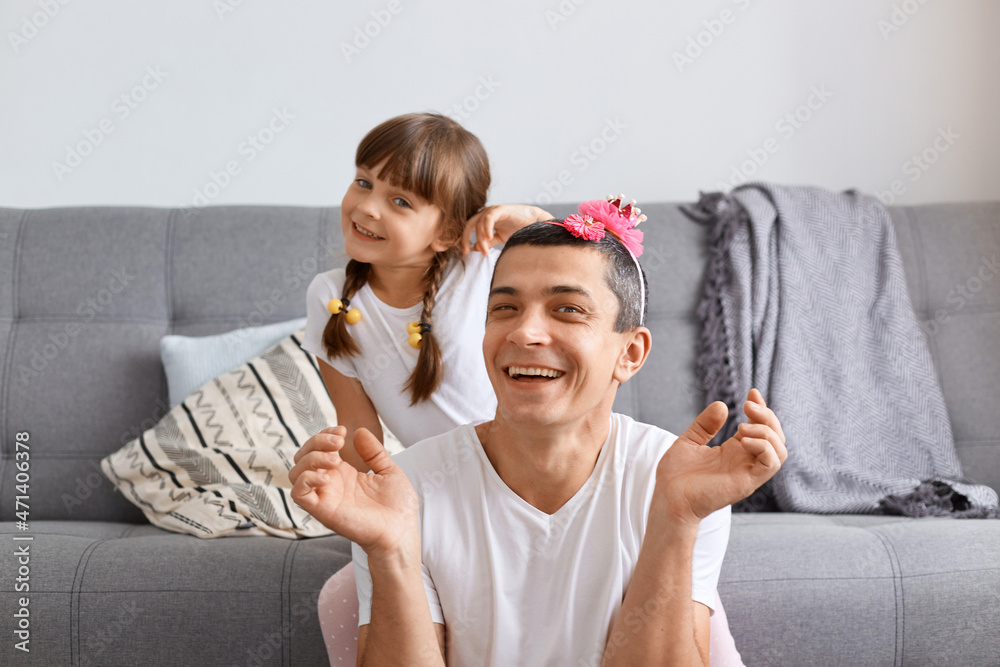 Indoor shot of happy positive man expressing positive emotions while ...