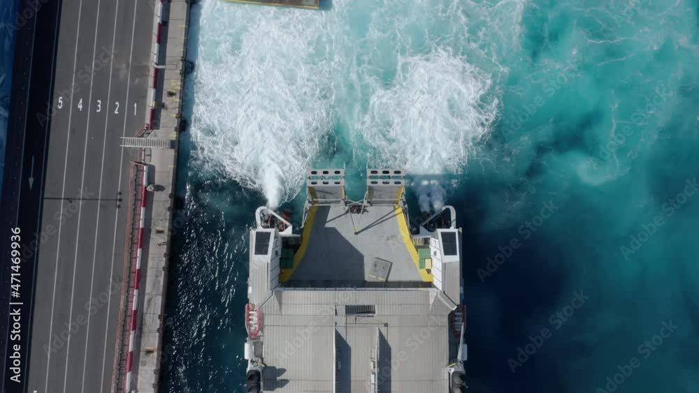 Modern passenger catamaran ship docking in port for loading and ...
