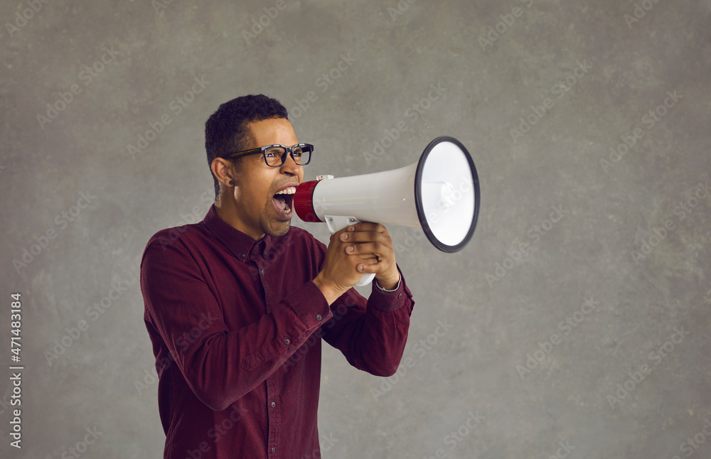 Excited agitated crazy young black man yelling in marketing megaphone ...