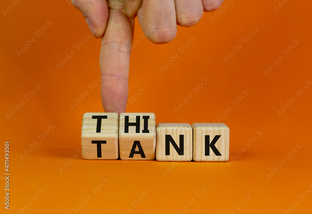 Think tank symbol. Businessman turns wooden cubes and changes the word ...