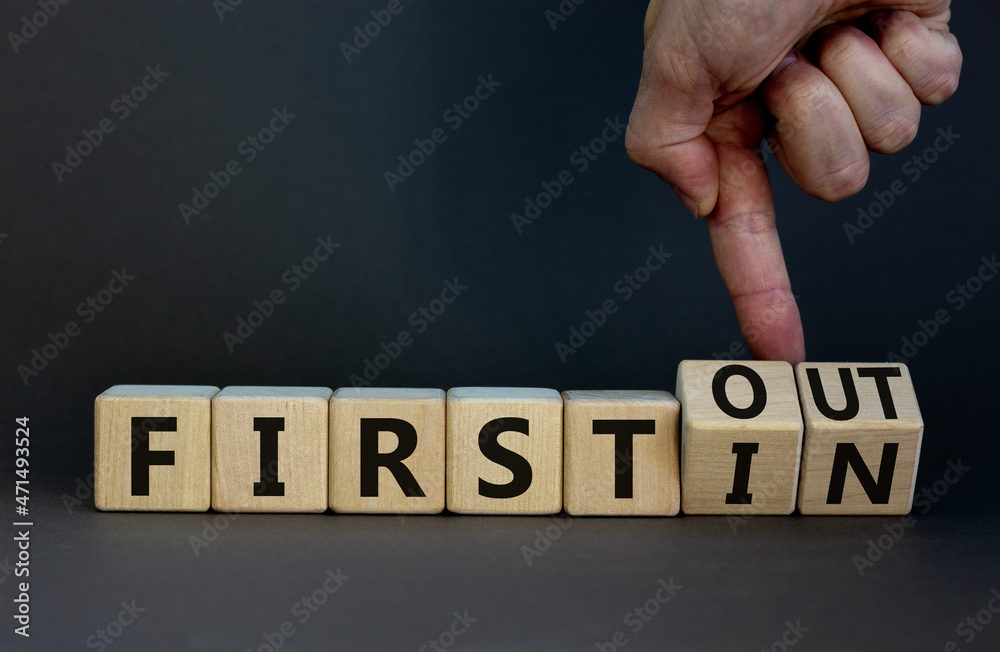 First in first out symbol. Businessman turns wooden cubes and changes ...