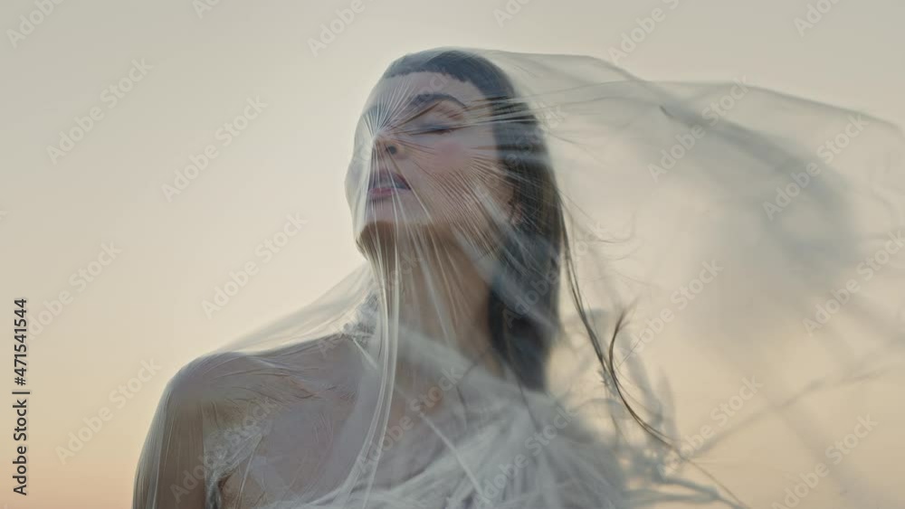Face Of Young Girl In Polyethylene Dress. Wind Blows Long Dress ...