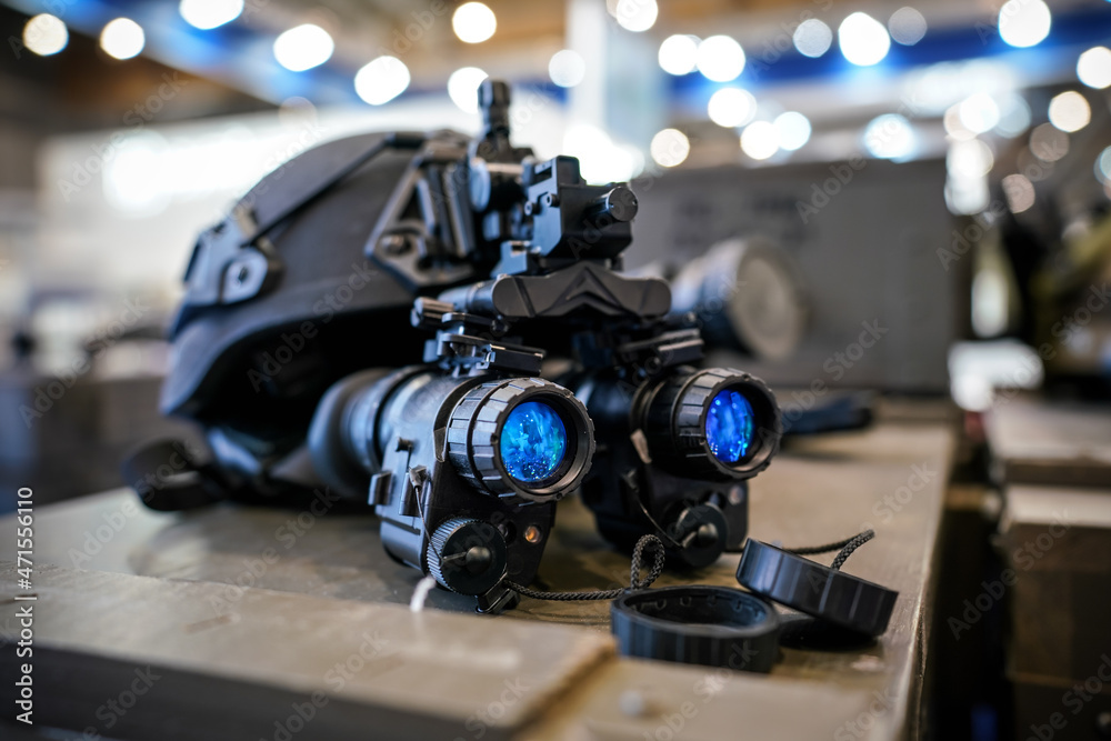 Night vision goggles on military helmet, closeup detail to blue ...
