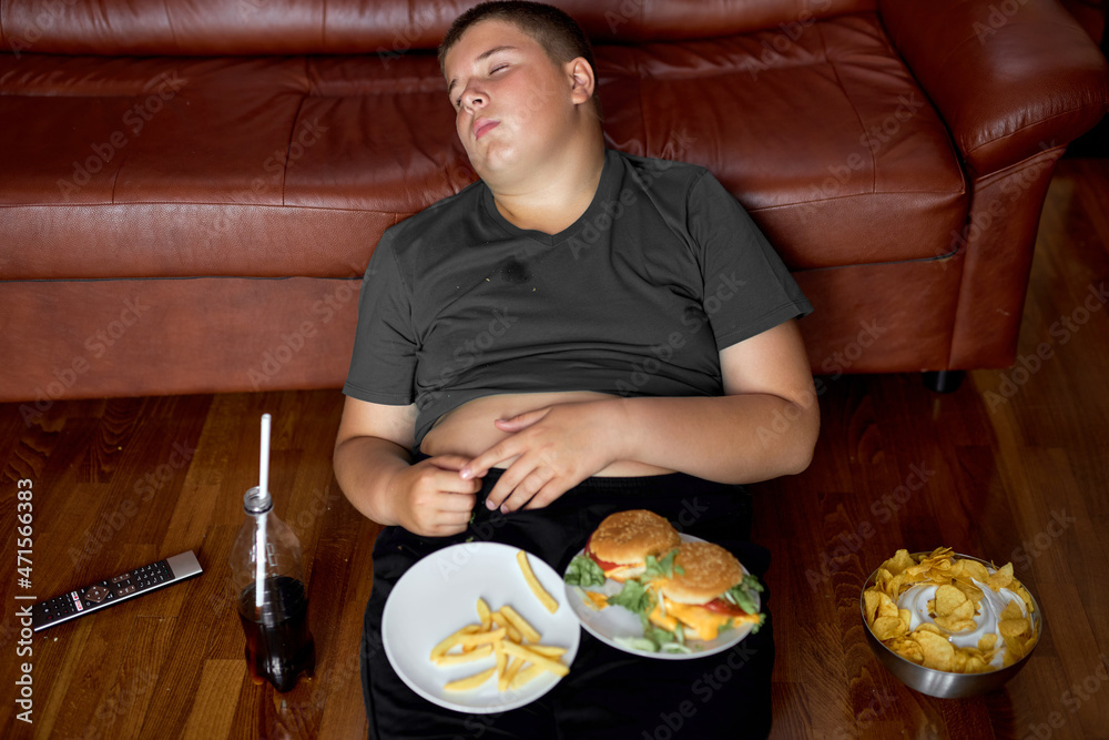 overeat boy sleep on floor in living room, young caucasian teen boy ...