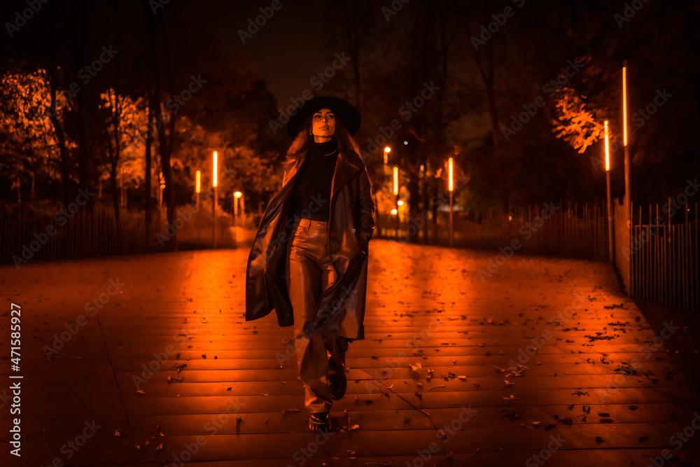 Girl with a hat walking calmly through a park on a winter night Stock ...