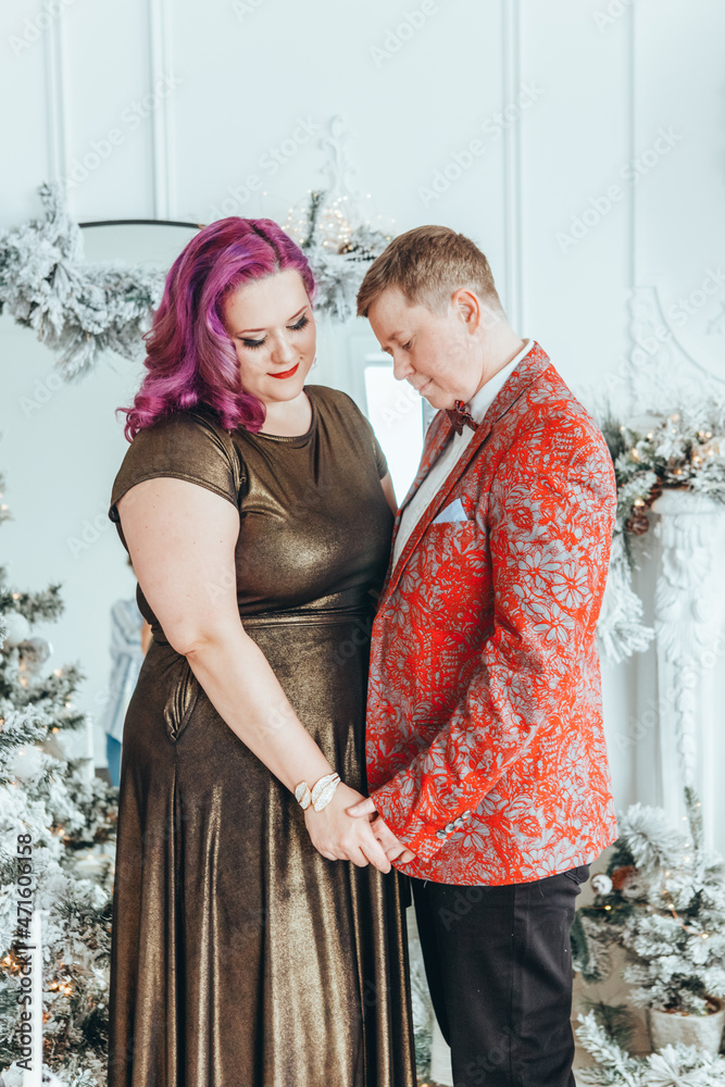 LGBTQ lesbian couple celebrating Christmas or New Year winter holiday ...