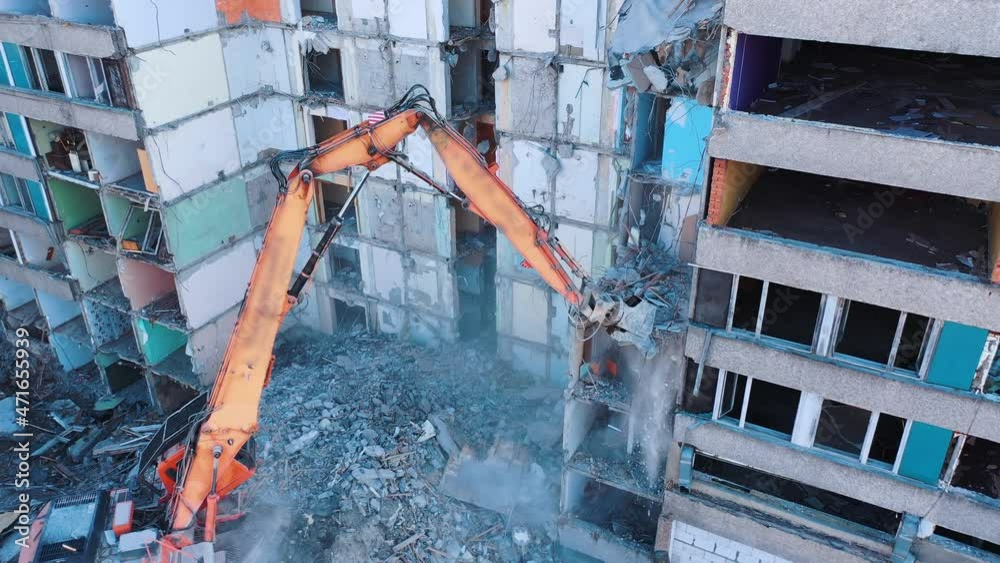 Ruined building is being demolished with the help of special machinery ...