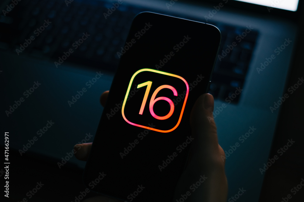 iPhone 13 pro with iOS 16 logo on the screen close up, new operating ...