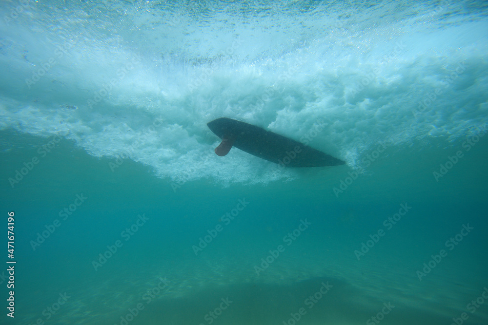 surfboard with a fin going through the water. Photographed from ...