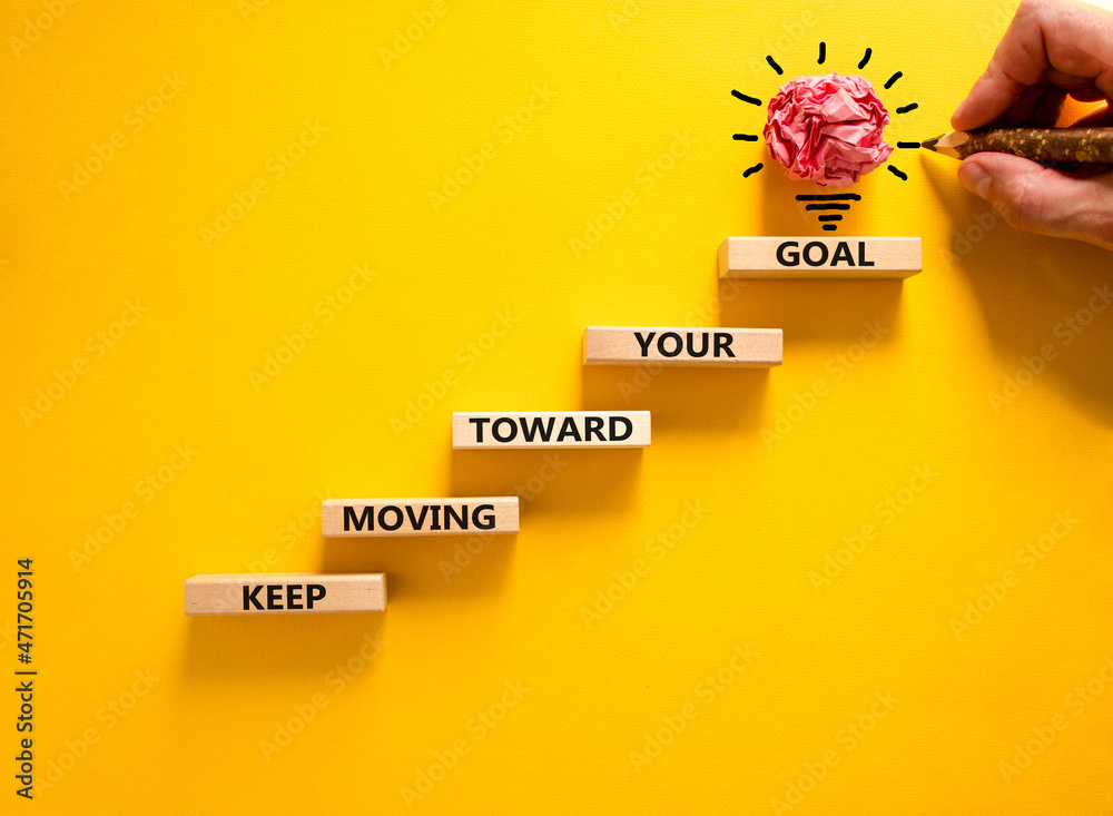 Keep moving toward your goal symbol. Wooden blocks with words Keep ...