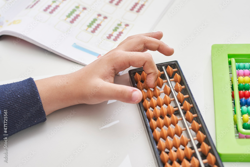 Schoolboy do mental math. Mental mathematics. 8 years old multiracial ...