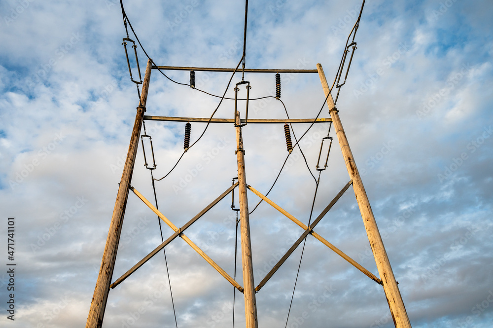 Electrical transmission lines supported by wooden towers on a stormy ...