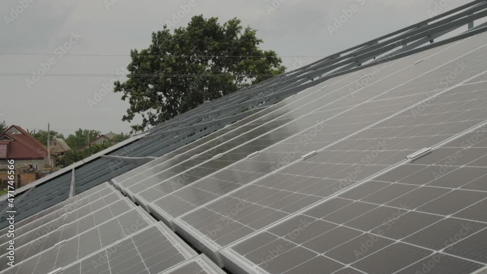 Solar panels at substation. Modern solar cells onto unfinished cottage ...