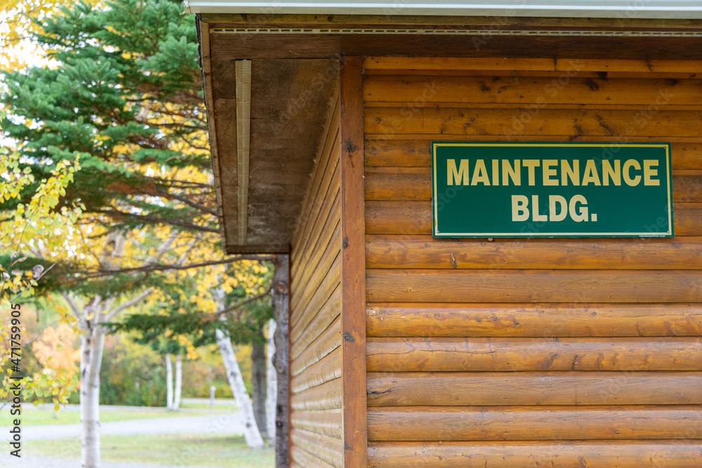The exterior of a maintenance building with wood log siding walls. A ...