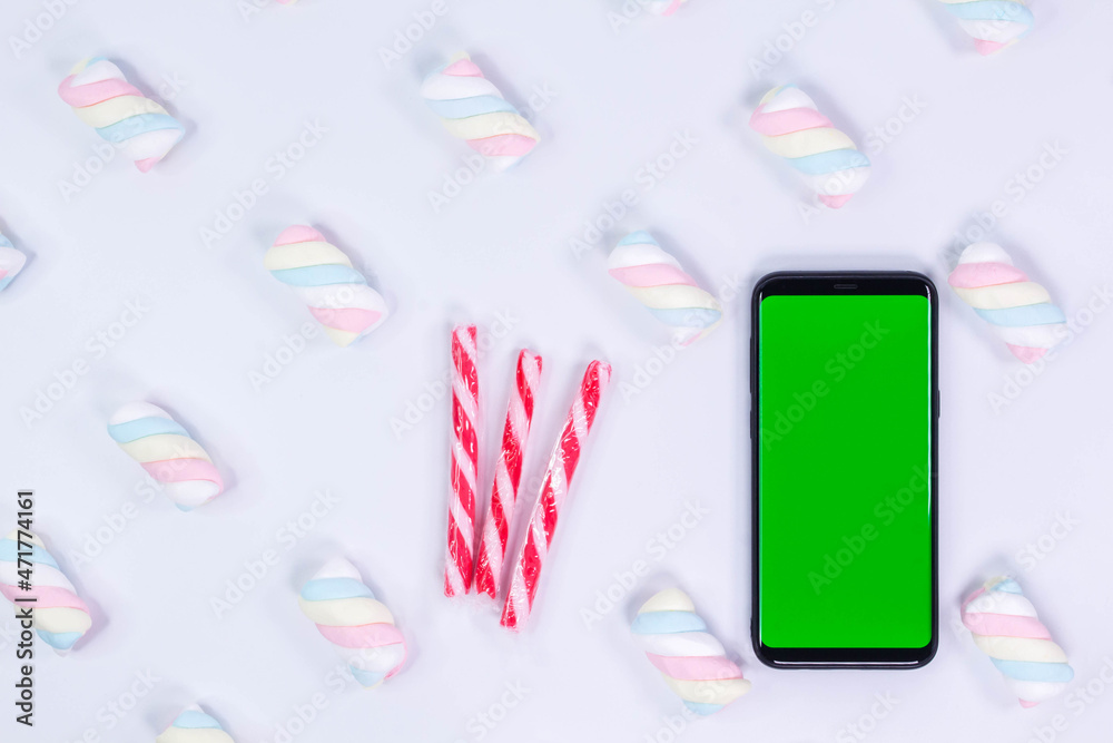 Phone mobile telephone with a vertical green screen. Candy cane ...