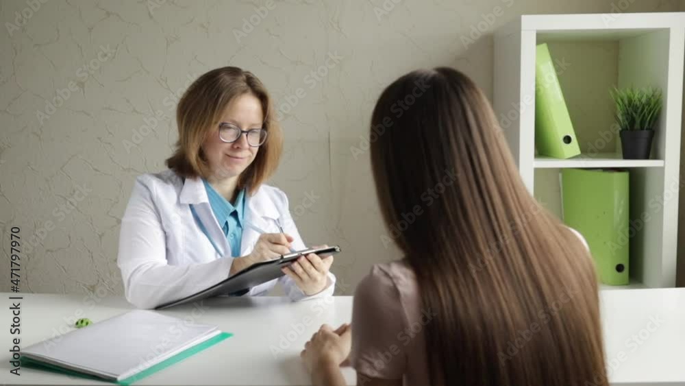 teenager in the hospital at doctor's appointment in medical office ...