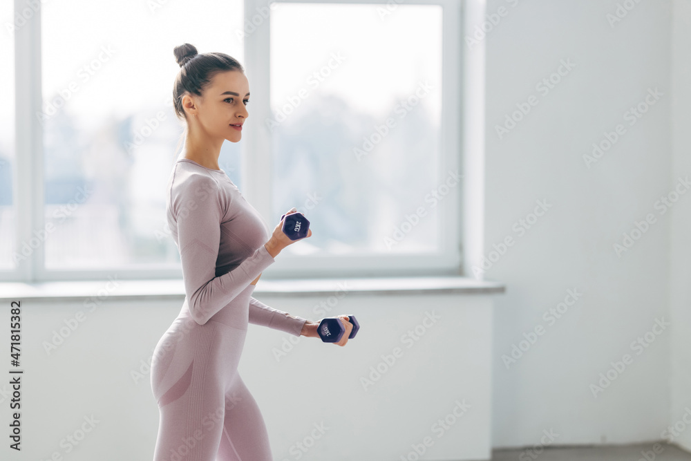 Athletic woman doing exercise for arms. Photo of muscular fitness model ...