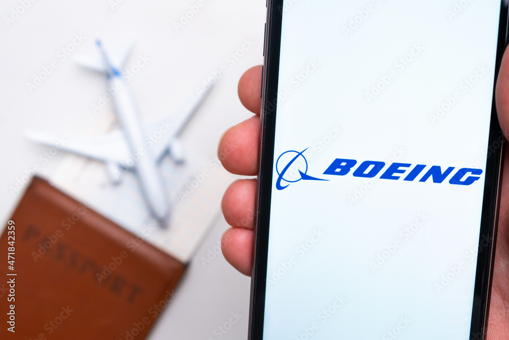 Boeing Airlines app logo on the screen of mobile phone. A blurry image ...