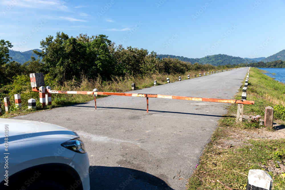 The barrier close the road. loses the passage for cars. Traffic ...
