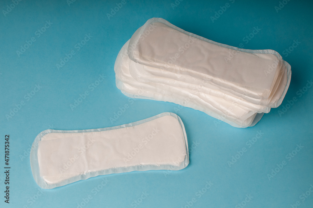 Feminine hygiene pads for the menstrual cycle on a blue background ...