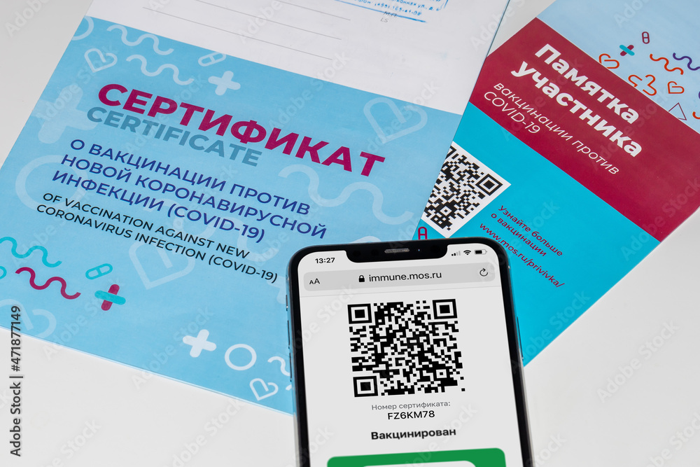 A valid COVID-19 vaccination QR code on the iPhone screen. Statuses ...