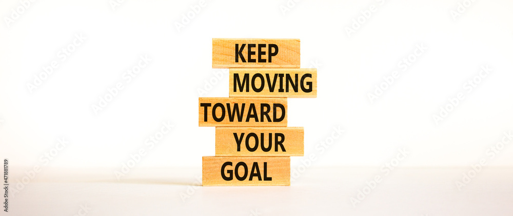 Keep moving toward your goal symbol. Wooden blocks with words Keep ...