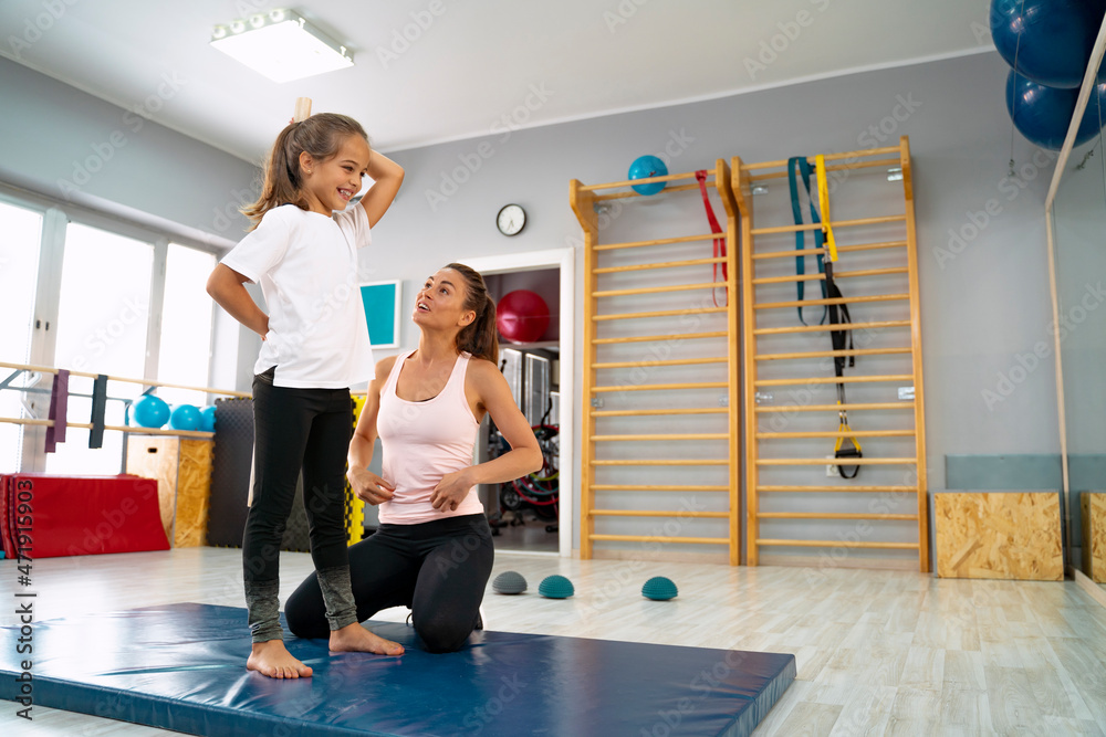 Cute little girl with physiotherapist. checking posture and spine Stock ...