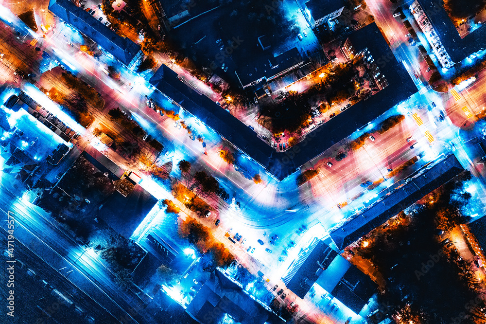Aerial view of the night city in winter. Movement of cars on lighted ...