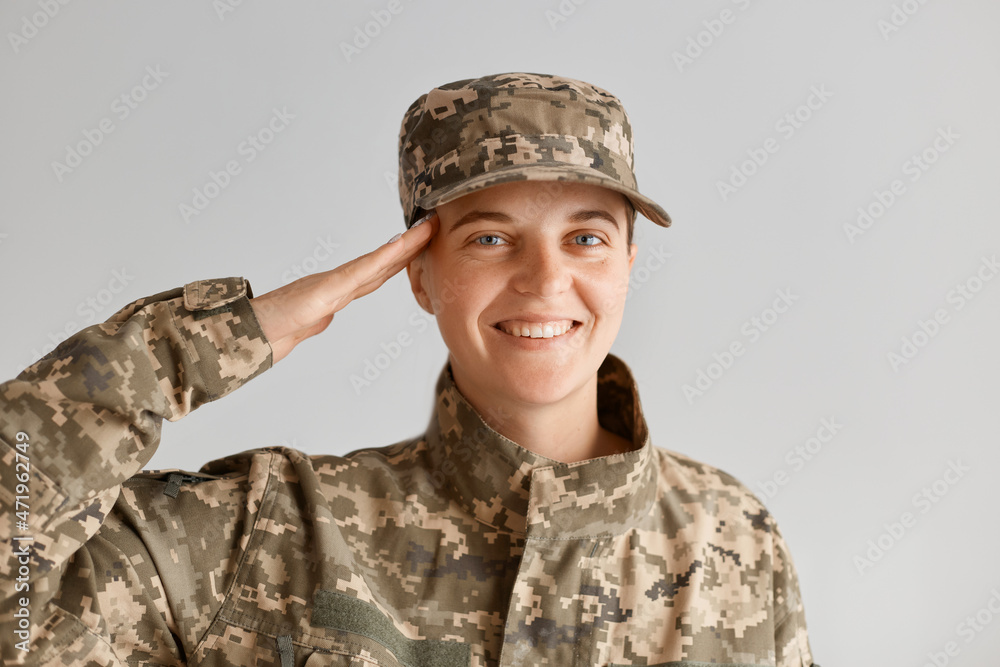 Portrait of happy smiling Caucasian woman army soldier saluting while ...