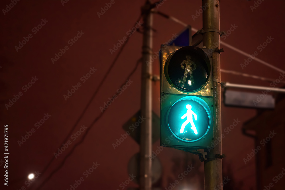 Pedestrian traffic light at night. Green light on pedestrian traffic ...