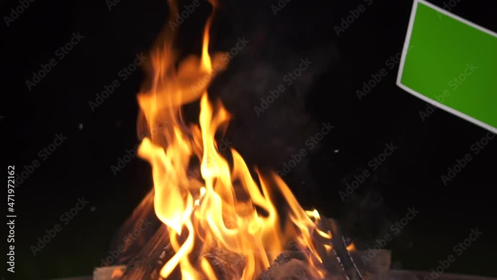 throw photo in firewood fire in dark. chromakey green. Burn fire ...