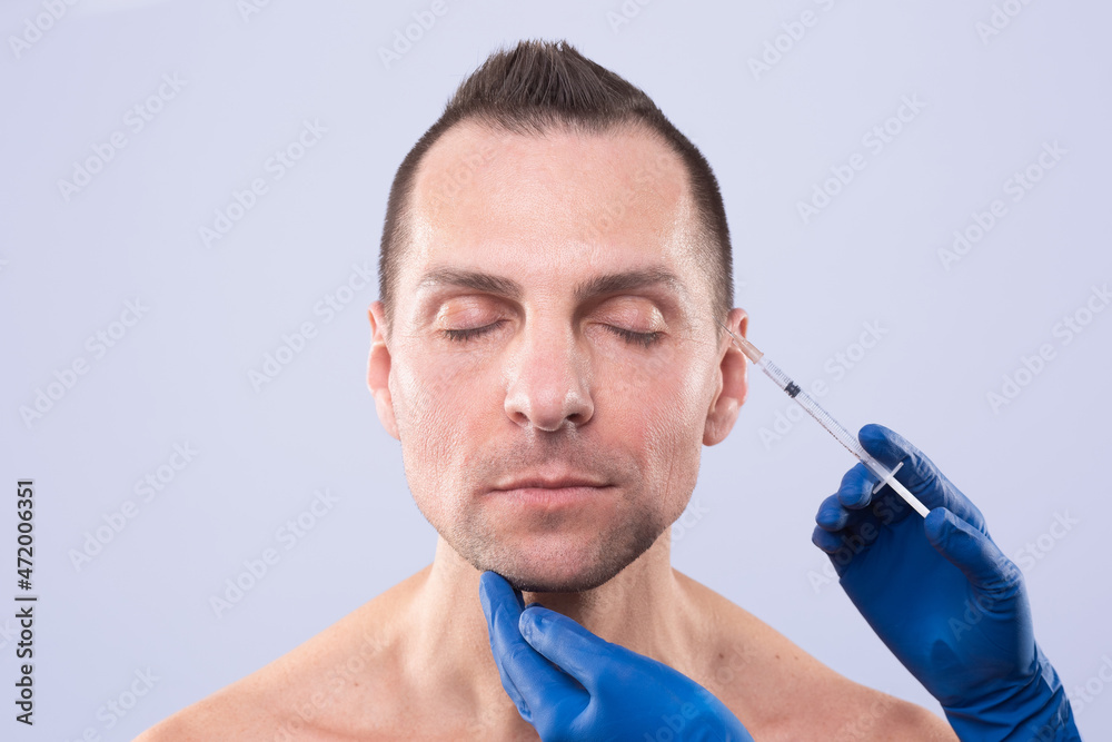 Plastic surgery concept. Man receiving injection in his face. Trendy ...