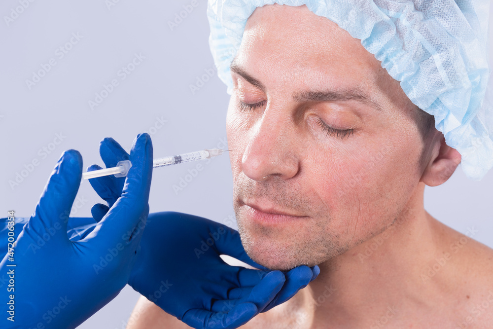 Plastic surgery concept. Man receiving injection in his face. Trendy ...