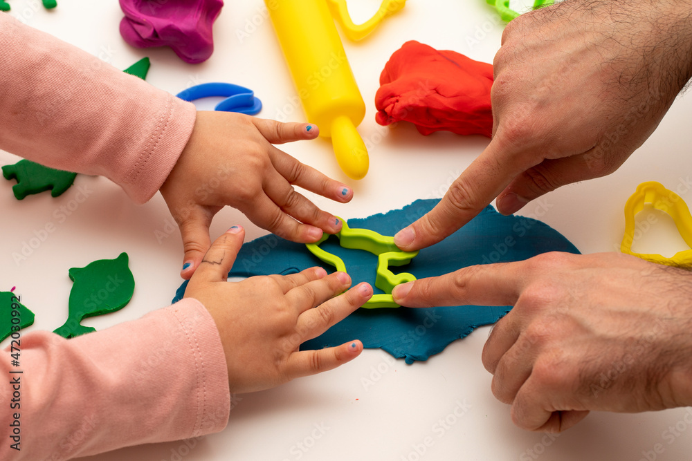 Girl playing dough with her father. father daughter playing game on ...