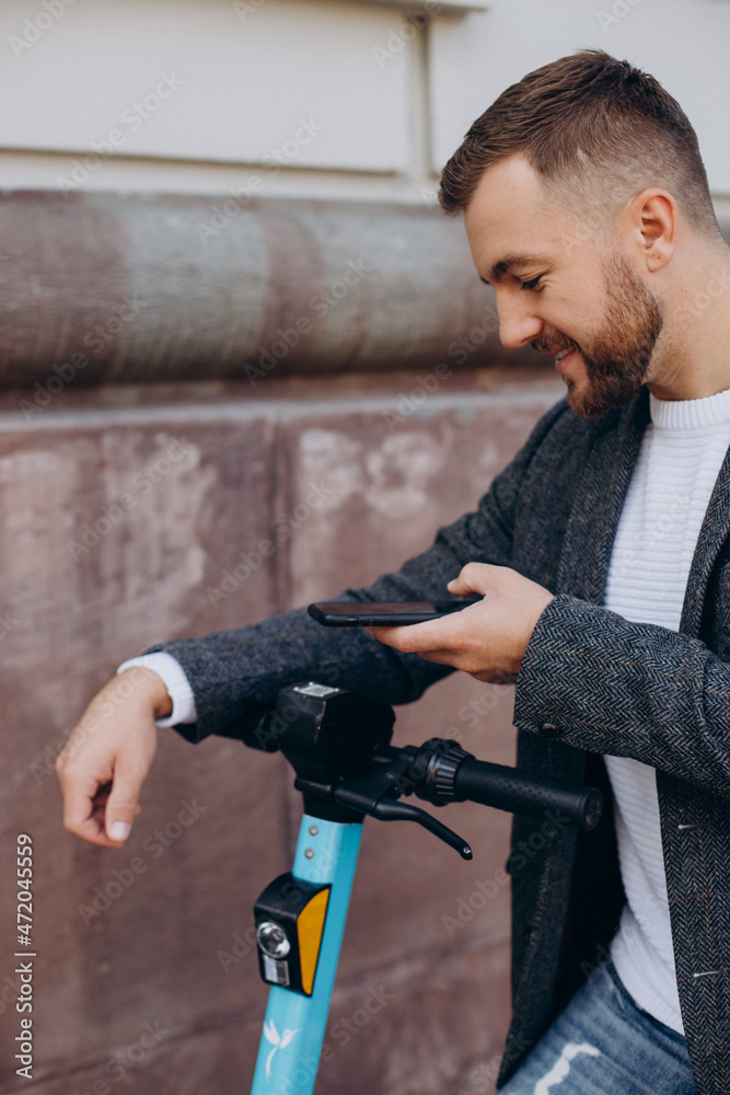 Man scanning qr code on electric scooter Stock Photo | Adobe Stock