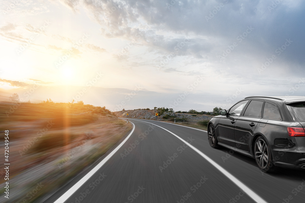 Black car on a scenic road. Car on the road surrounded by a magnificent ...