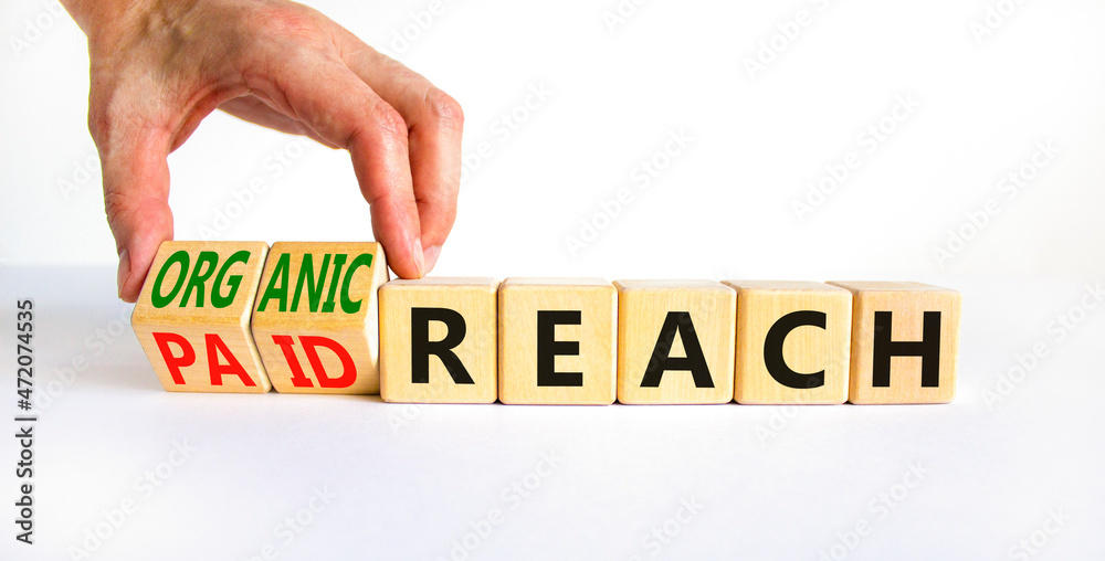 Organic or paid reach symbol. Businessman turns wooden cubes and ...