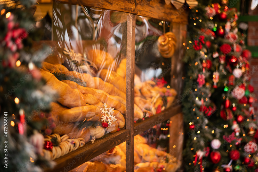 Old bakery window on christmas eve. Freshly baked bread and rolls are ...