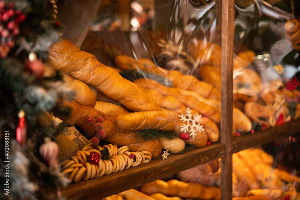 Old bakery window on christmas eve. Freshly baked bread and rolls are ...