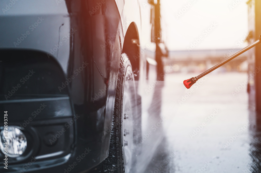 Car Wash detail. Vehicle During Washing Process. Manual washing wheels ...