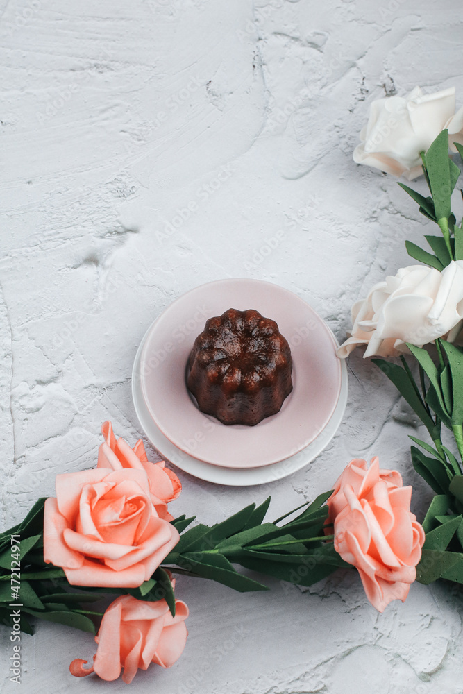 Caneles de bordeaux with rose traditional French sweet dessert on white ...