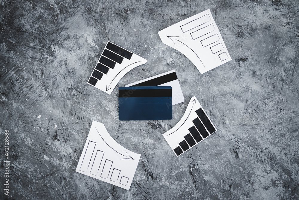 financial markets or money and investments, payment cards with charts ...